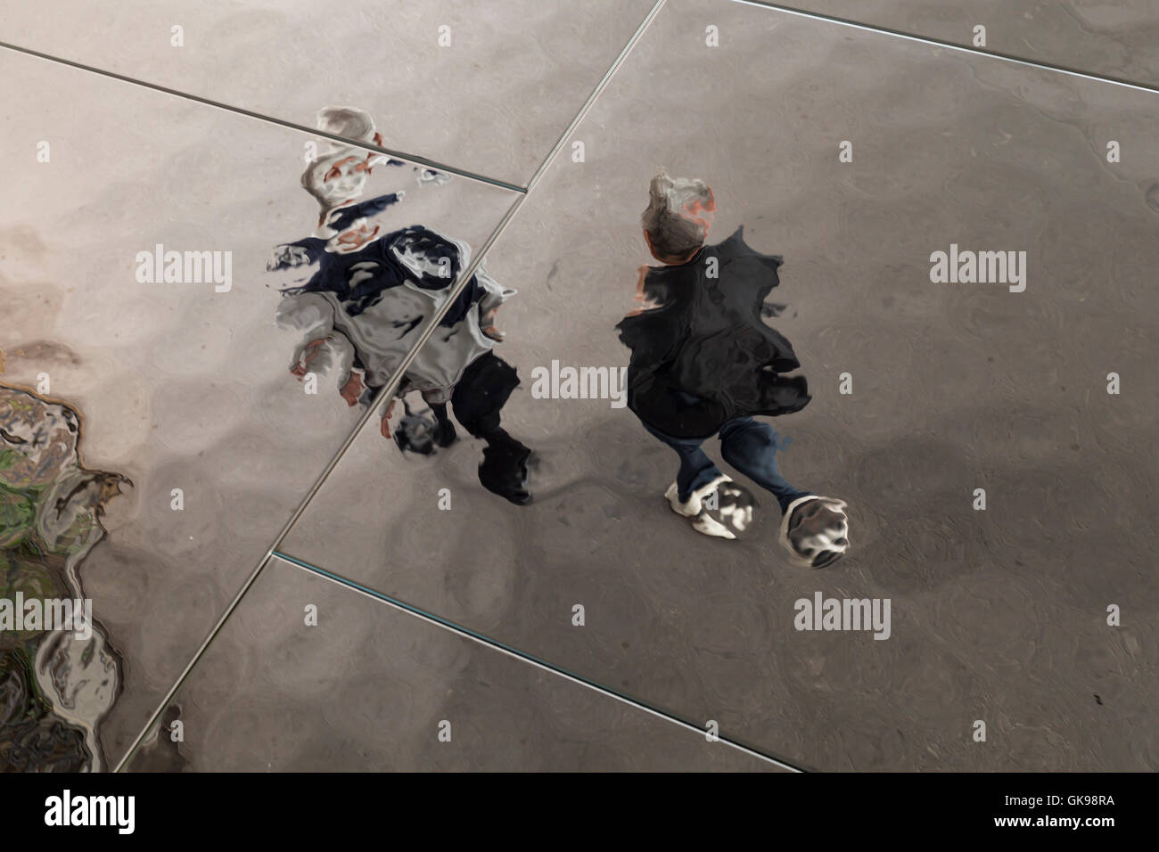 contorted reflections of people in a ceiling with mirrors Stock Photo ...