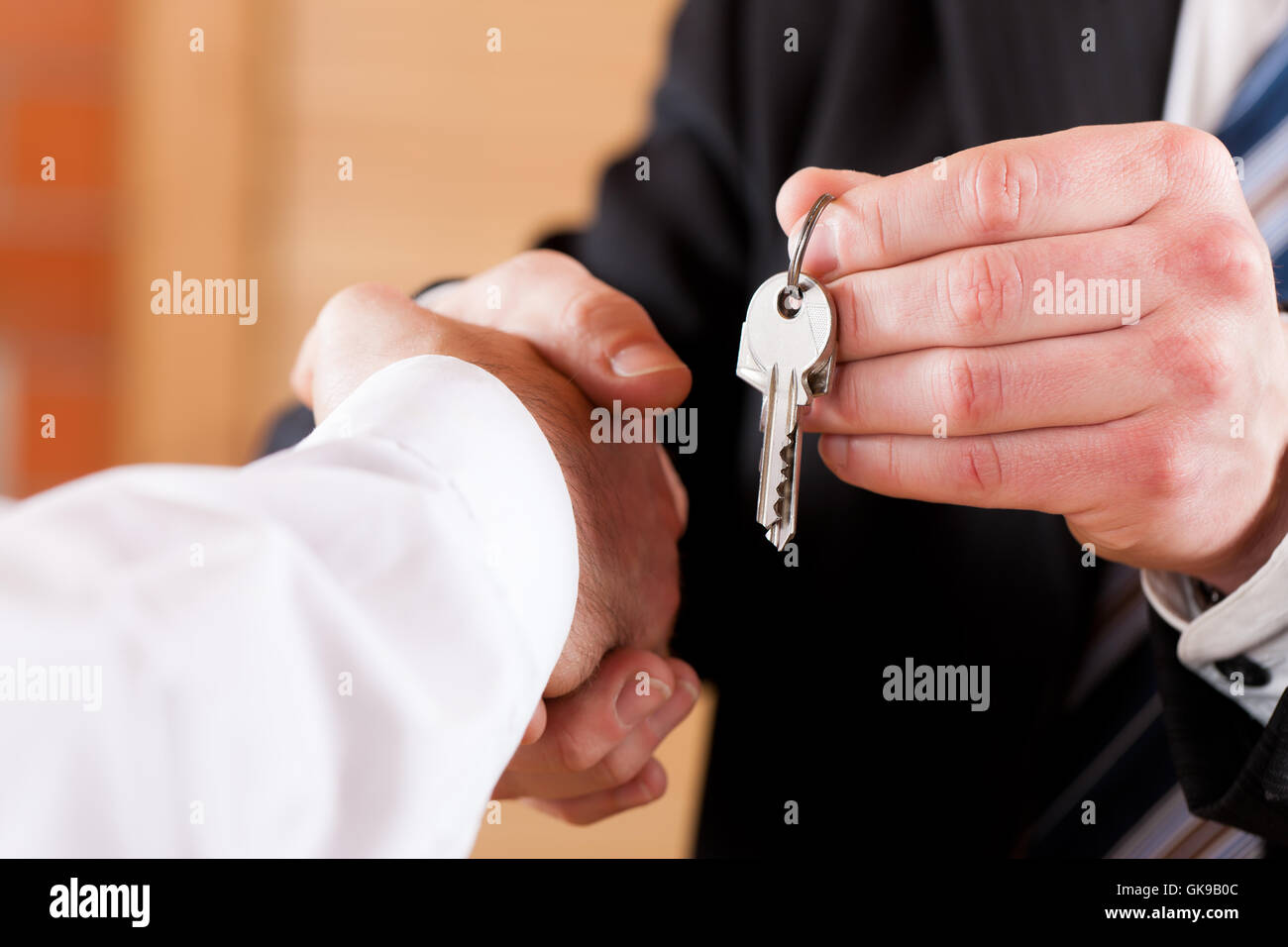handshake in business with keys Stock Photo - Alamy