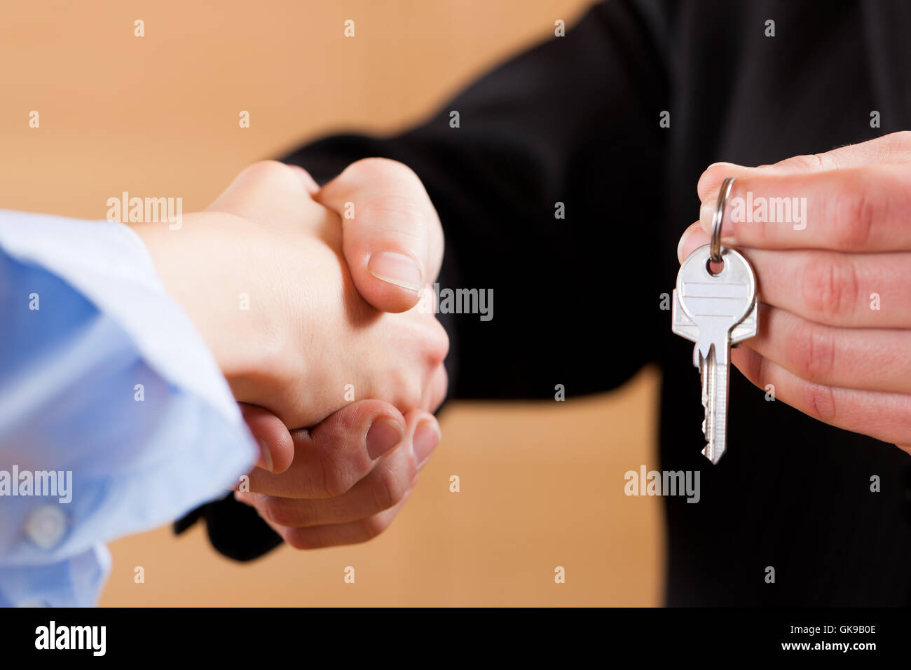 handshake in business with keys Stock Photo - Alamy