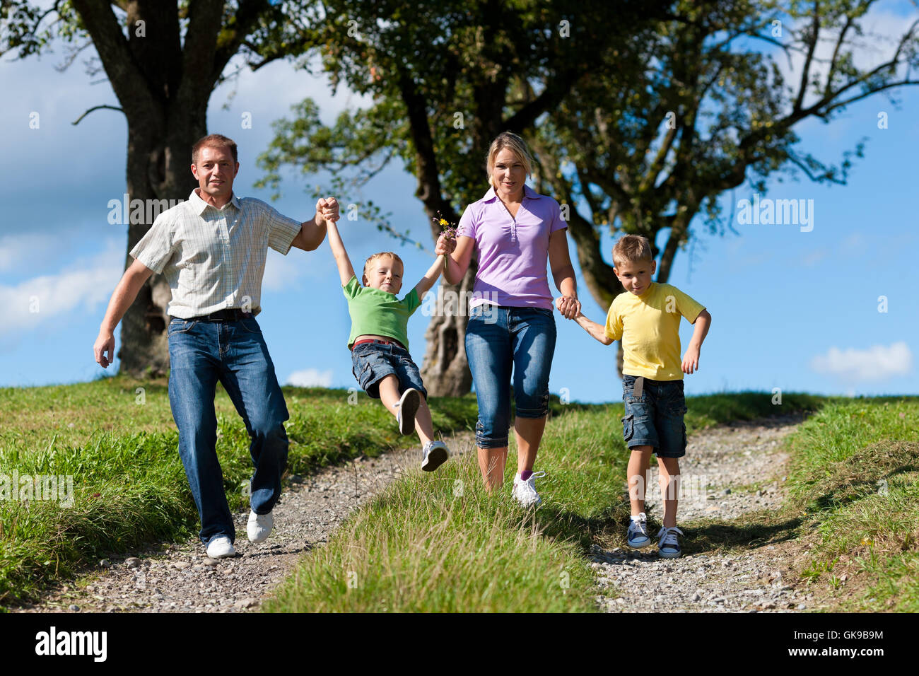 family outdoors is running on a dirt road Stock Photo - Alamy