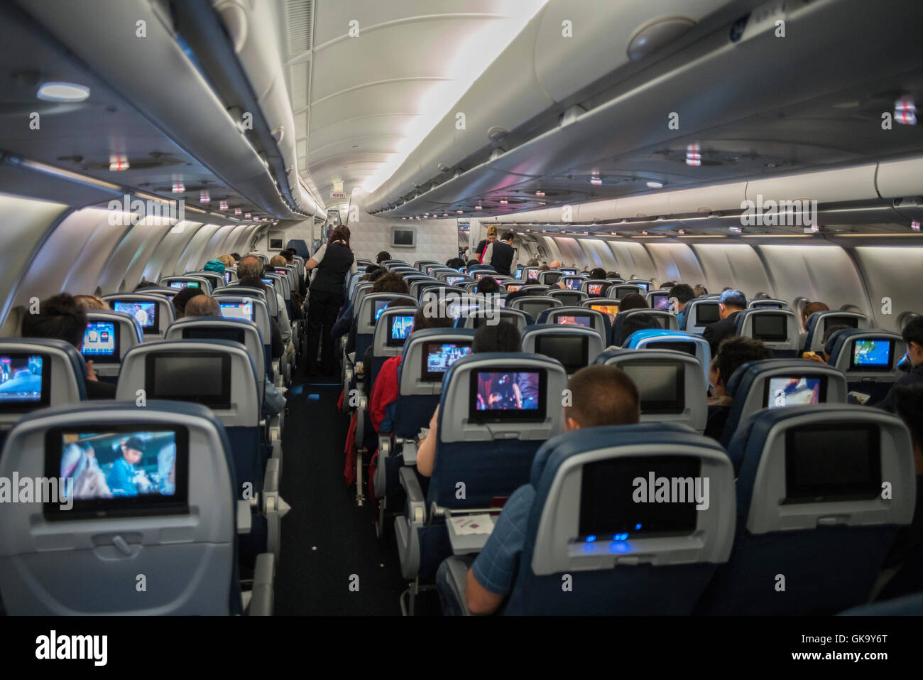 Commercial aircraft cabin aisle seat row Stock Photo - Alamy