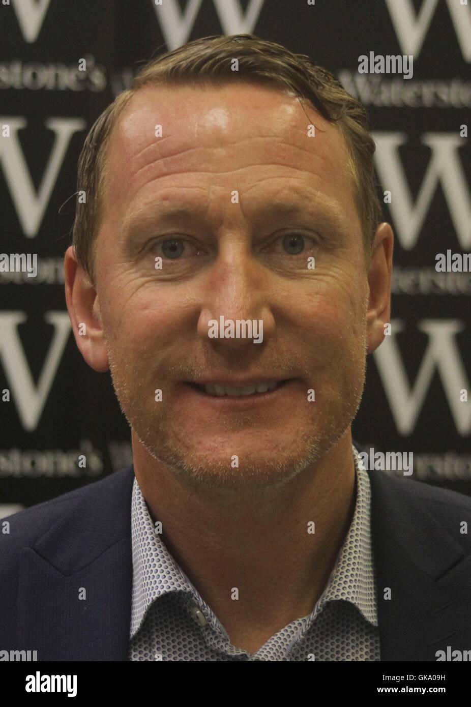 Former Arsenal football player Ray Parlour signs copies of his ...