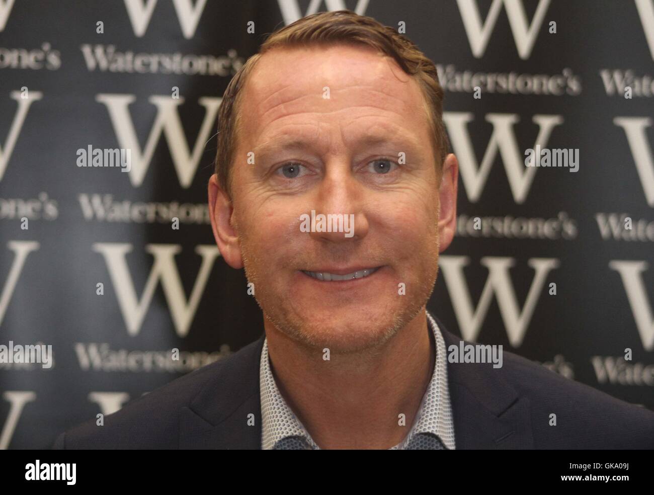 Former Arsenal football player Ray Parlour signs copies of his ...