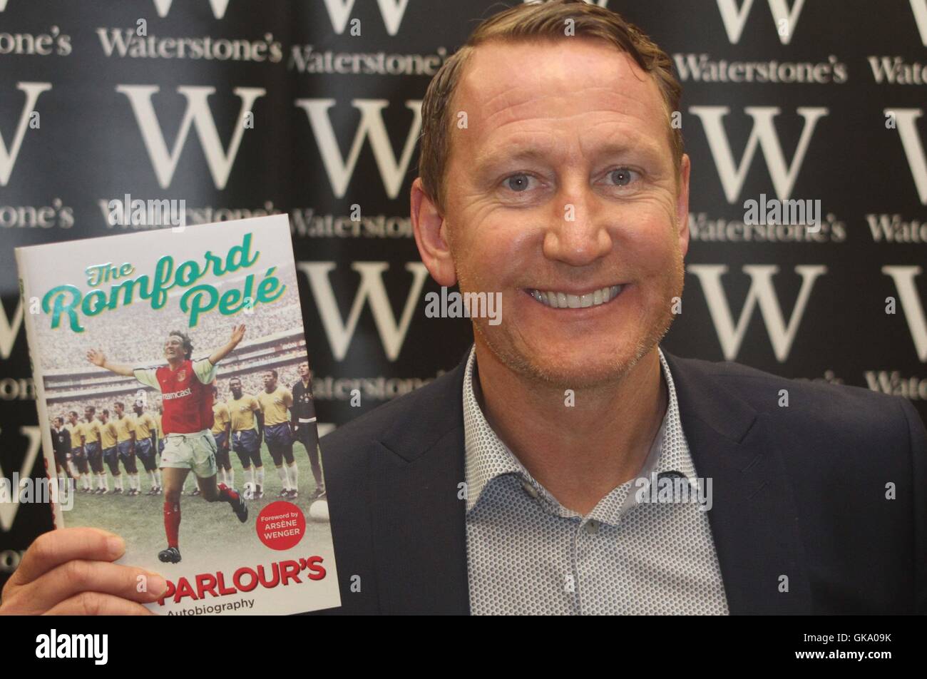 Former Arsenal football player Ray Parlour signs copies of his ...