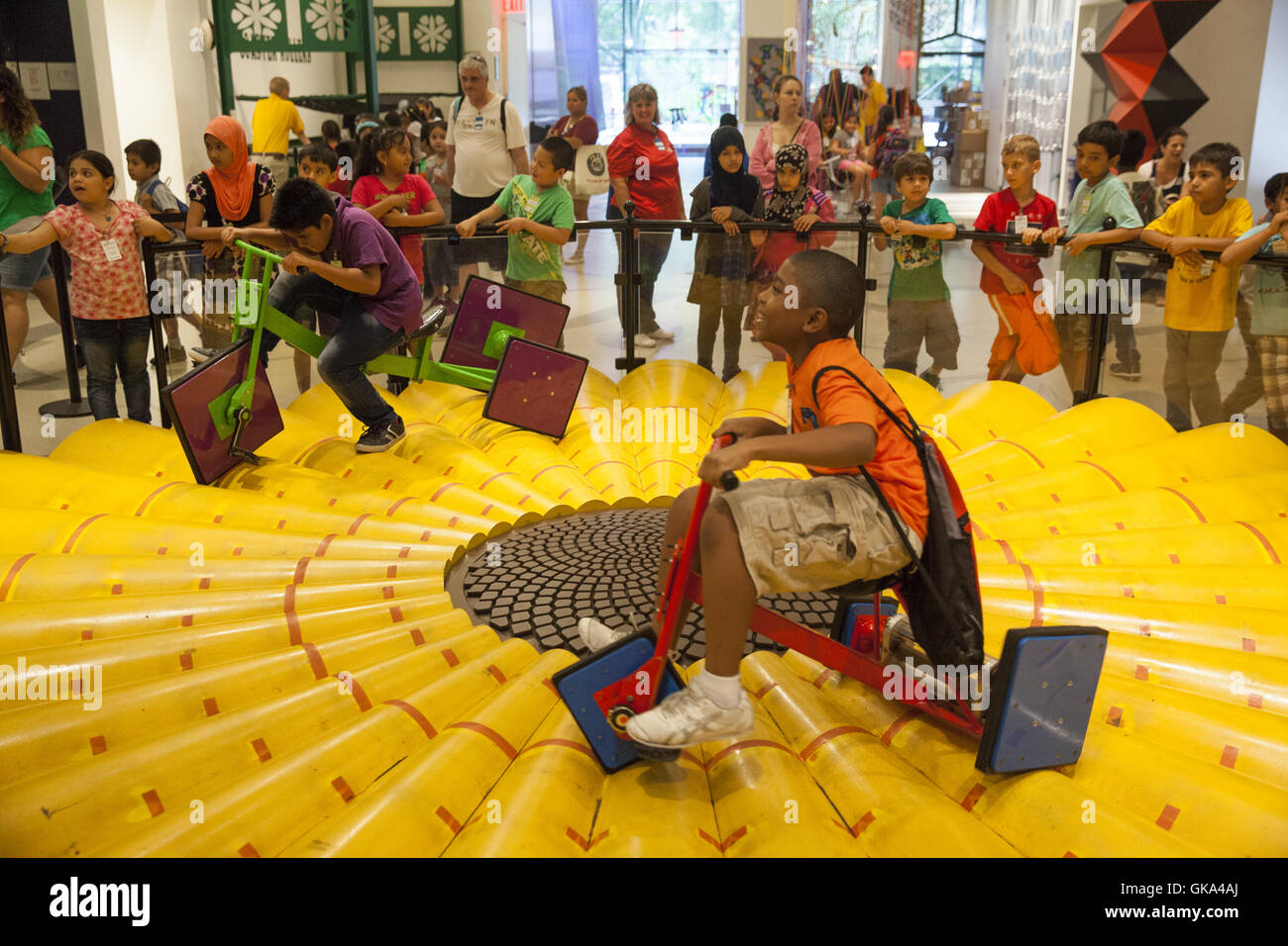 Children and adults explore mathematically based exhibits at the ...