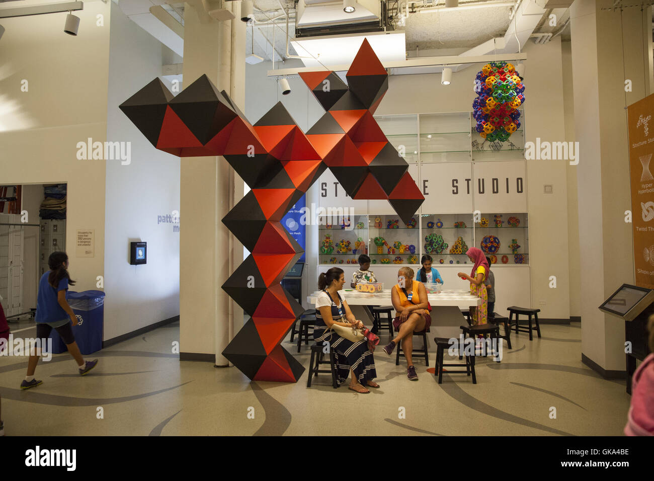 Children and adults explore mathematically based exhibits at the ...