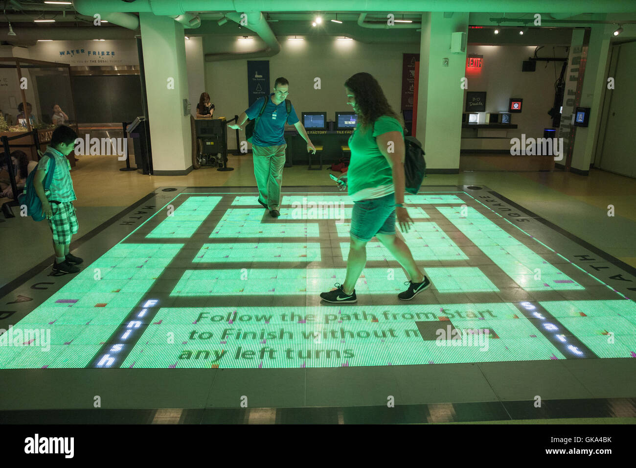 Children and adults explore mathematically based exhibits at the ...