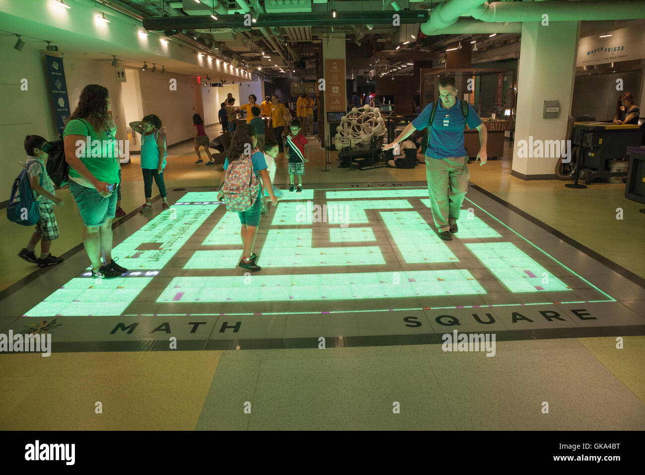 Children and adults explore mathematically based interactive exhibits ...
