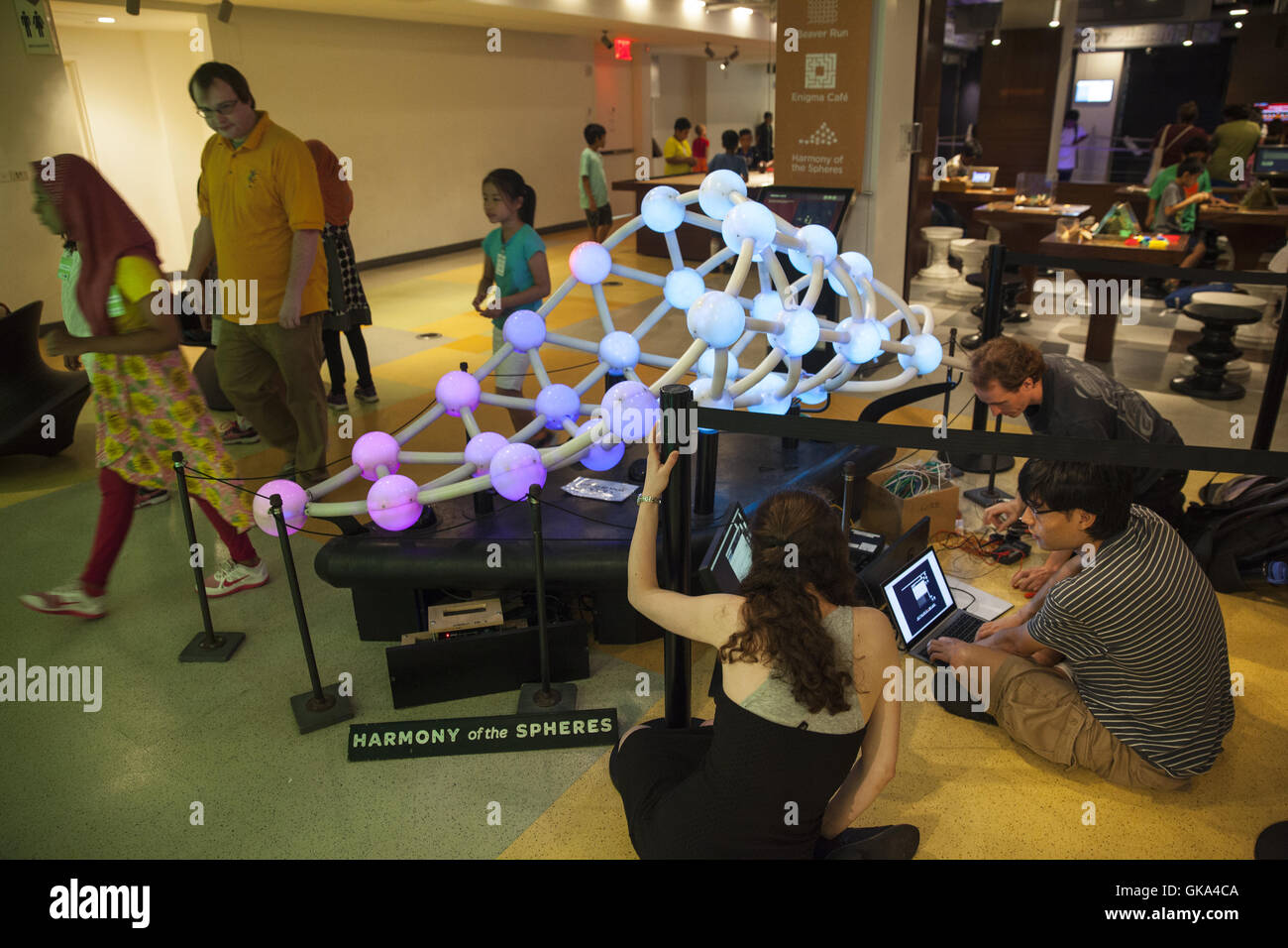 Children and adults explore mathematically based interactive exhibits ...