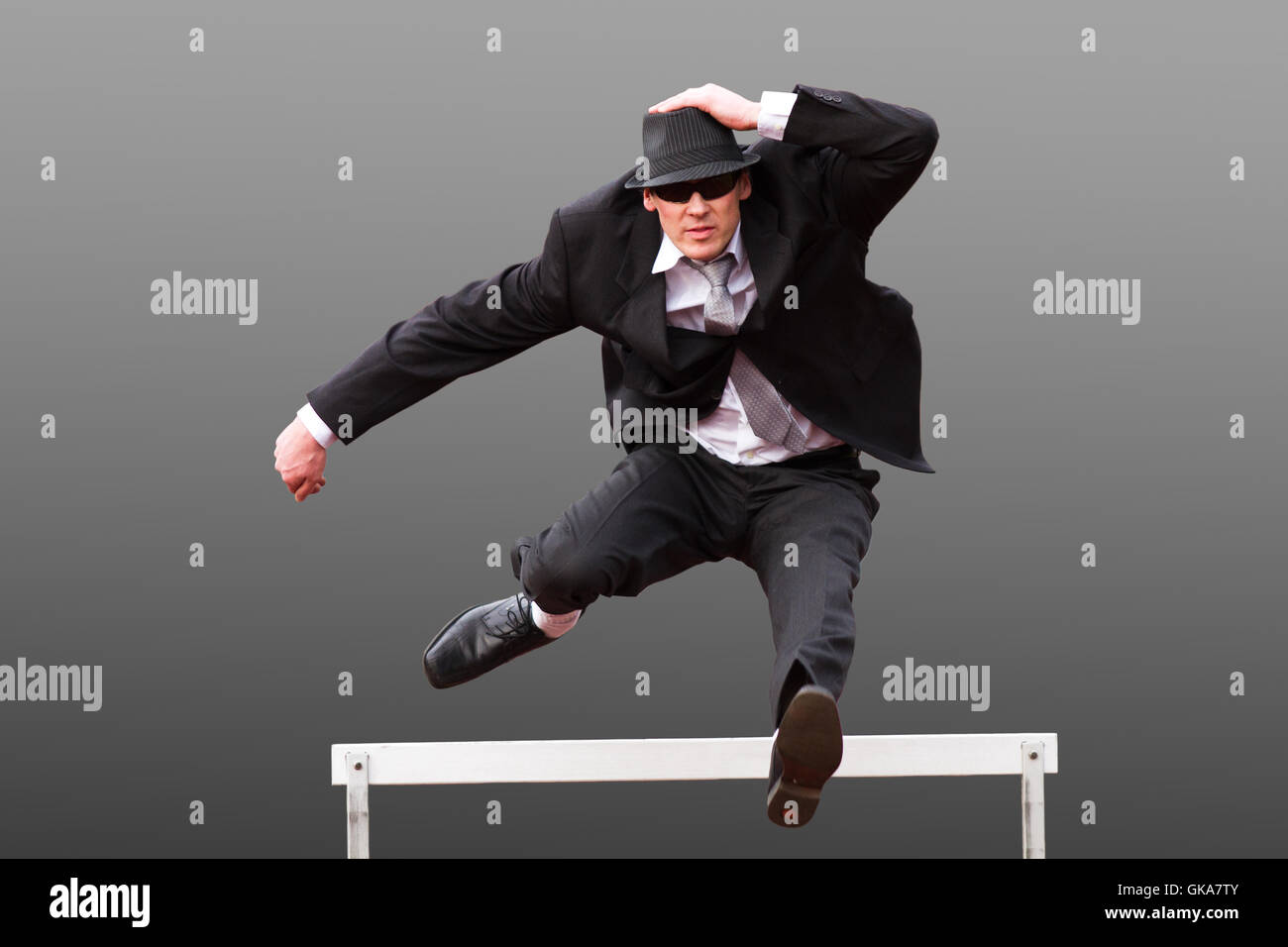 Businessman jumping hurdles hi-res stock photography and images - Alamy