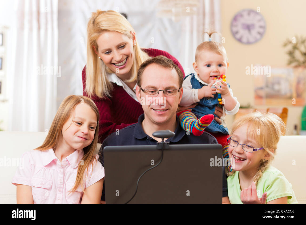 family in front of computer with video chat Stock Photo - Alamy