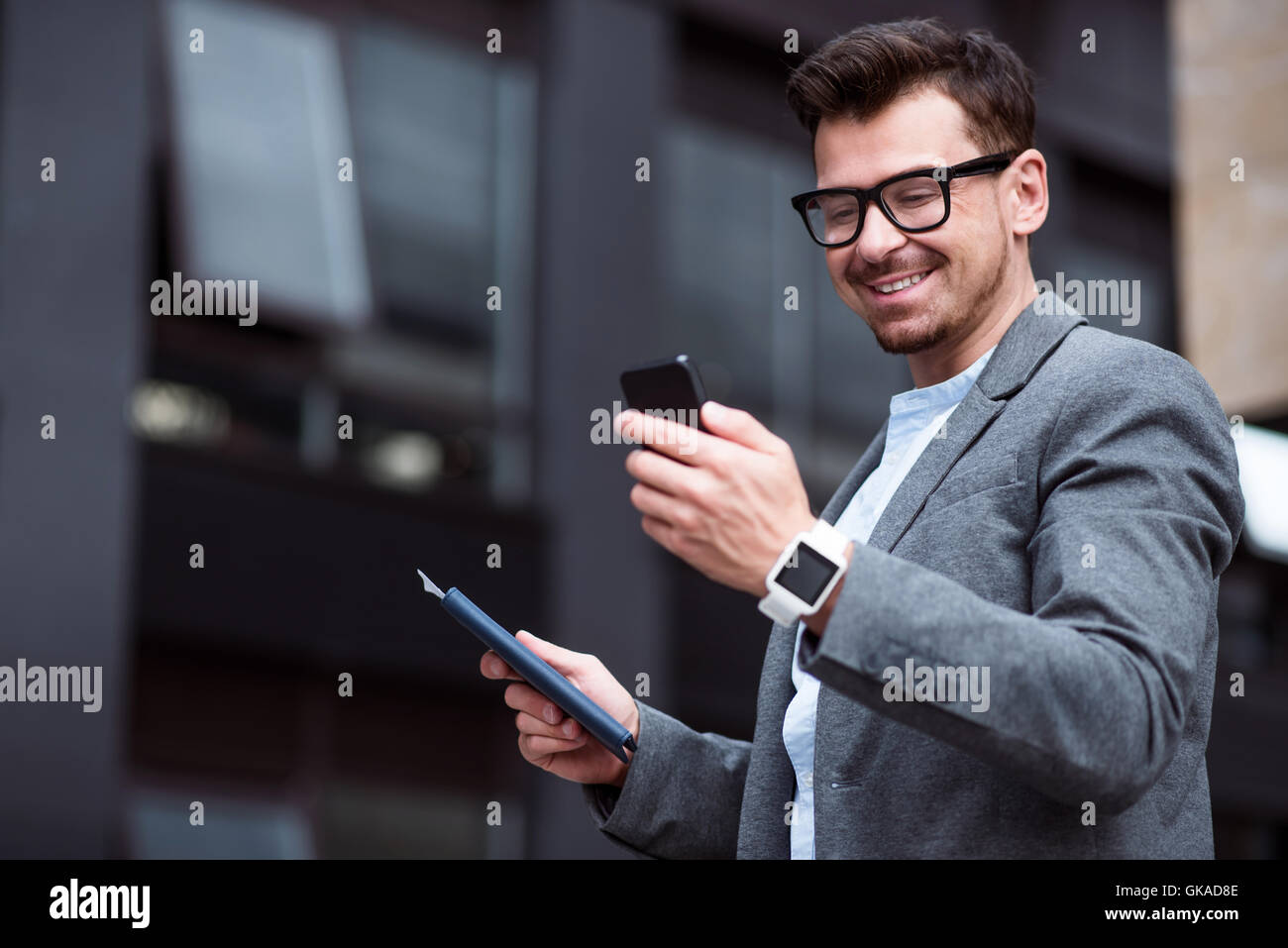 Positive woman holding cell phone Stock Photo - Alamy