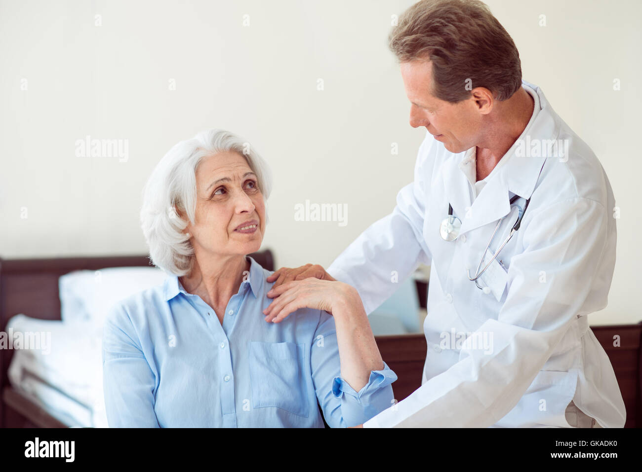 Doctor with old woman Stock Photo - Alamy