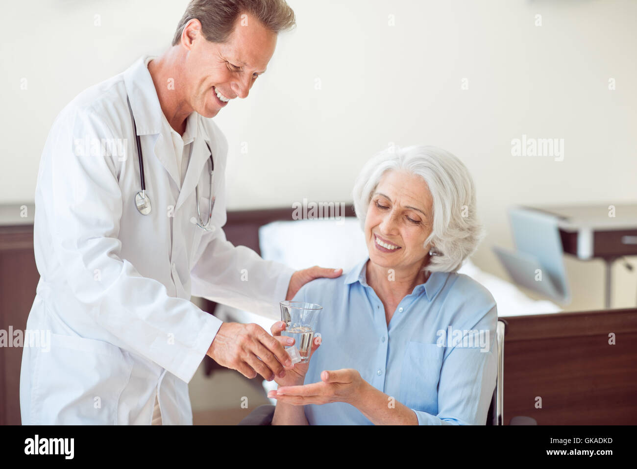 Senior patient taking pills Stock Photo - Alamy