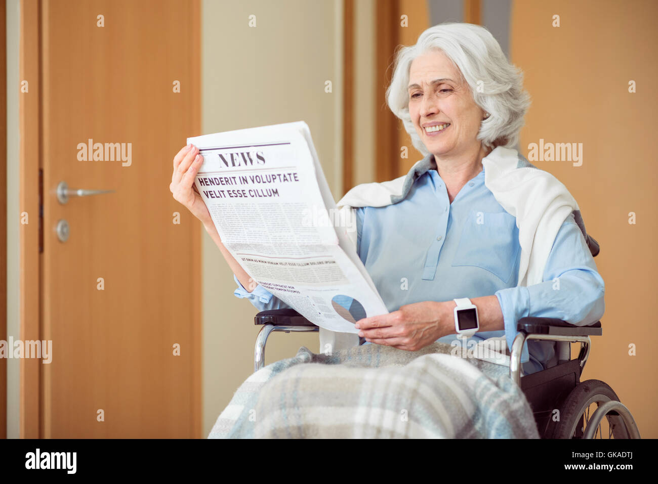 Senior female patient reading news Stock Photo - Alamy