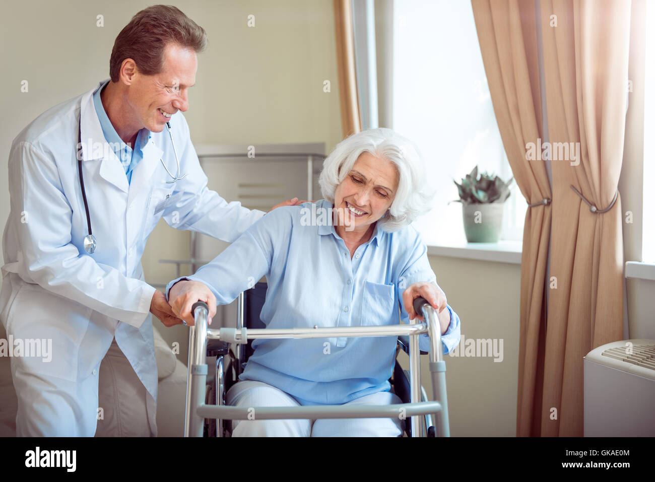 Young doctor helping female patient Stock Photo - Alamy