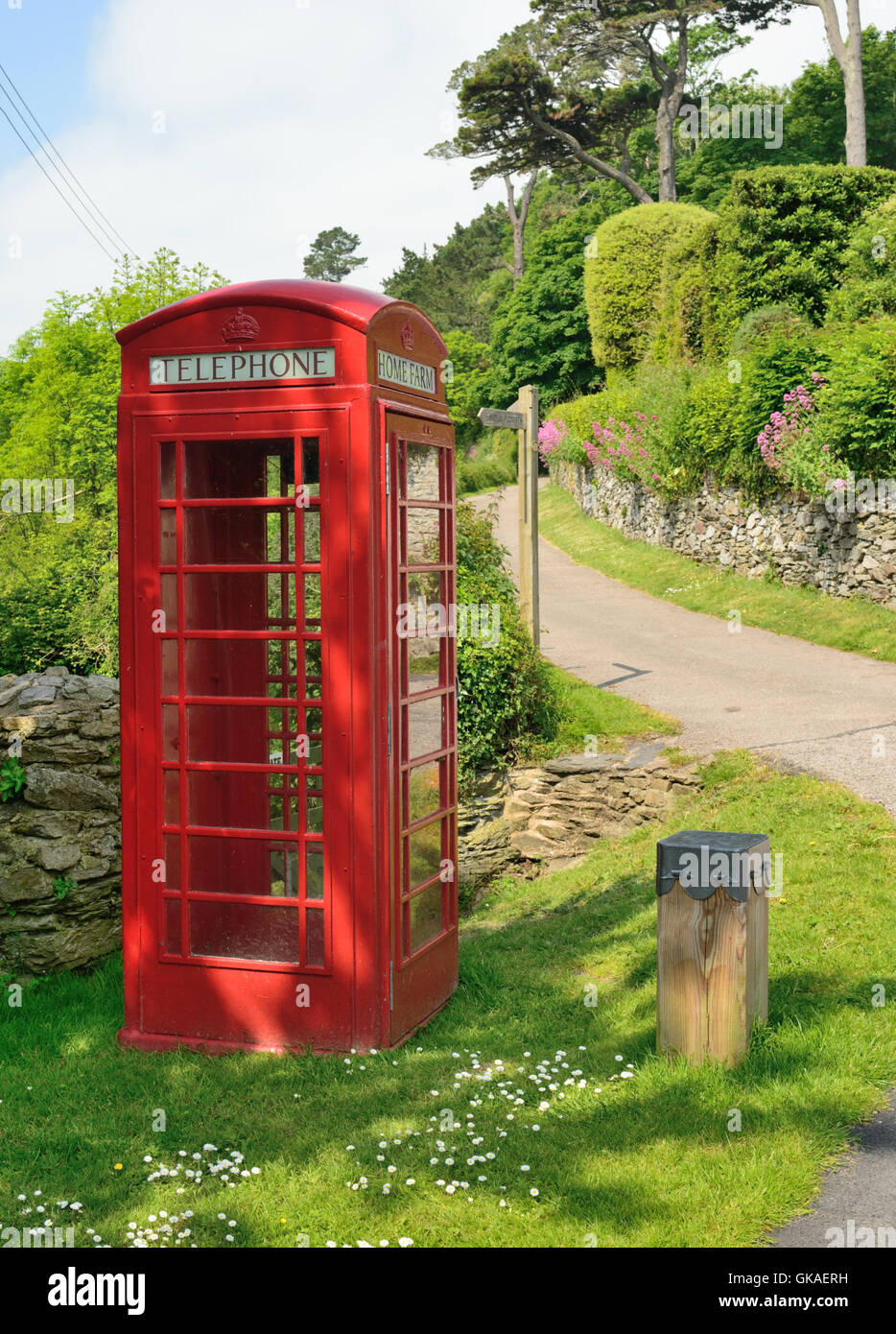 An empty red telephone box beside a country lane in a remote location ...