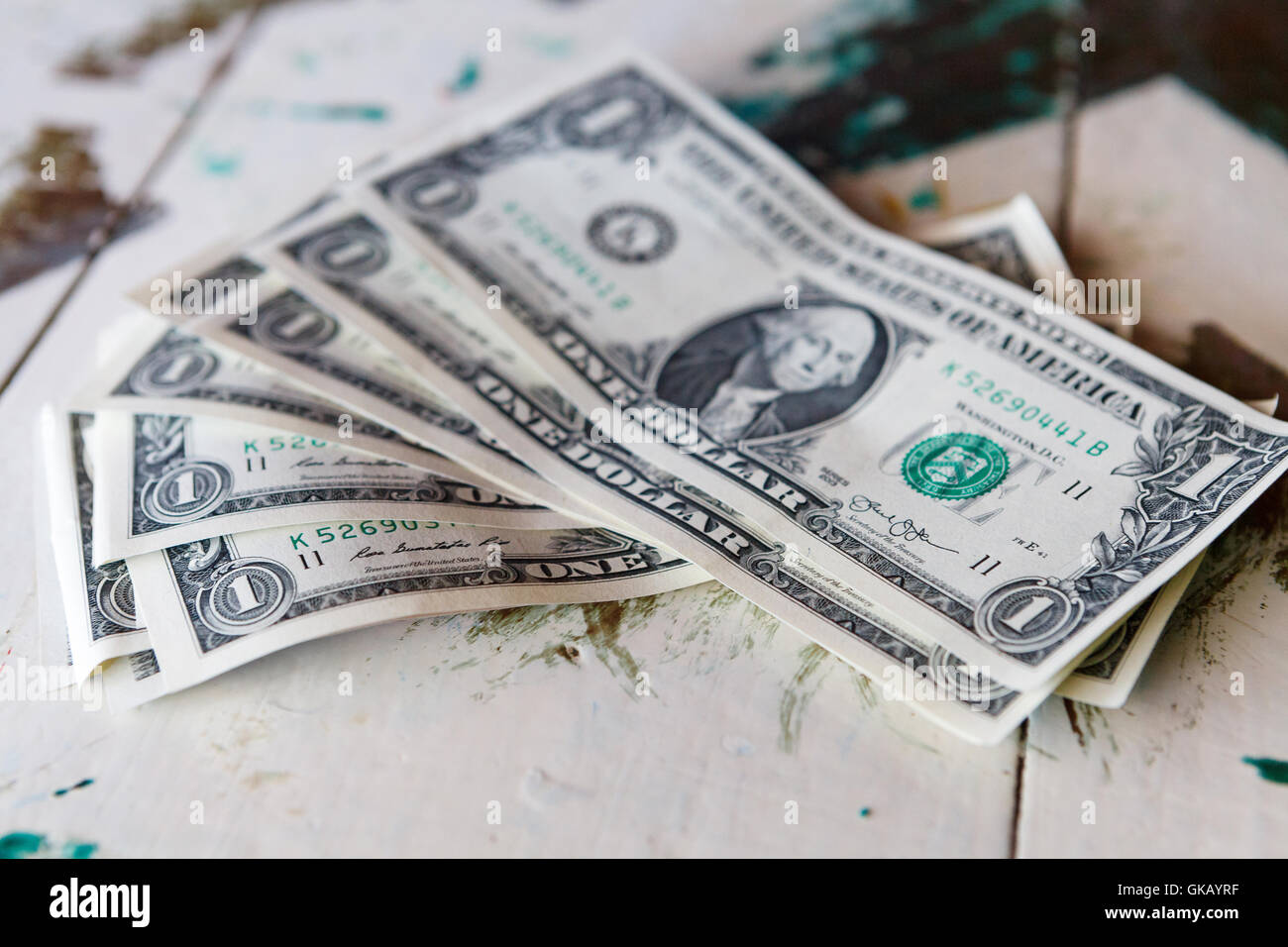 Money - USD one dollar bills on vintage table Stock Photo - Alamy