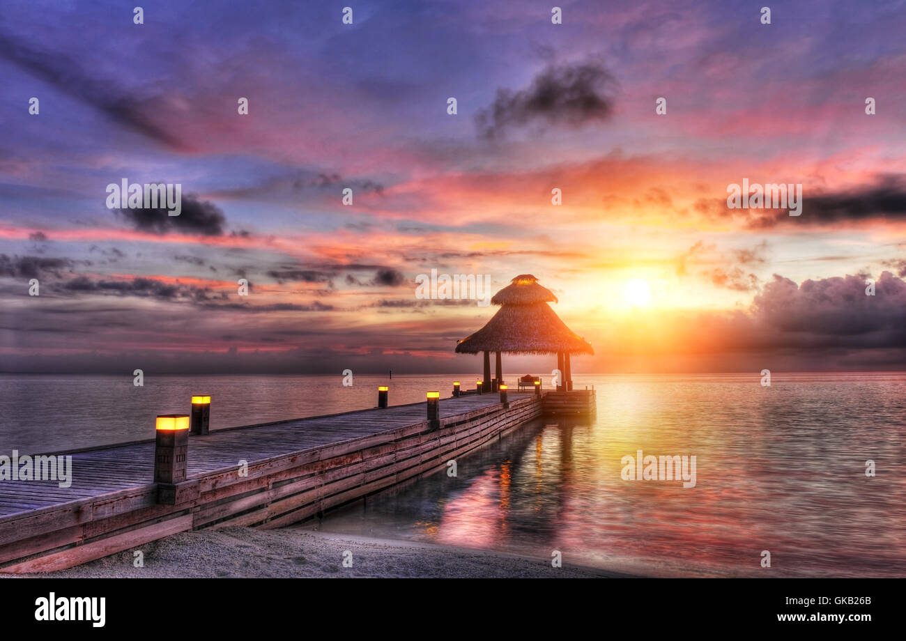 sunset maldives jetty Stock Photo - Alamy
