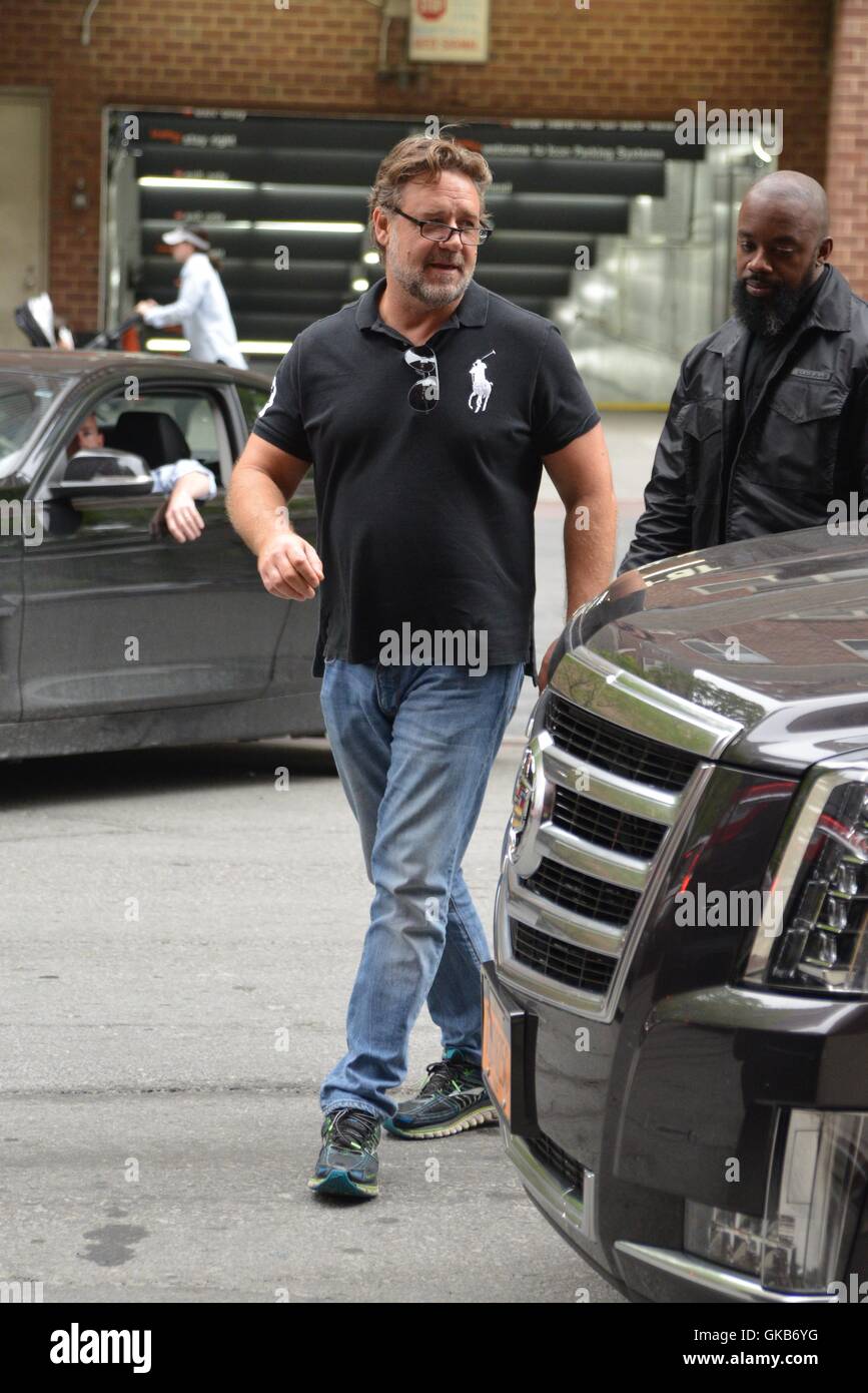 Russell Crowe appears in good spirits while posing with fans in Soho ...