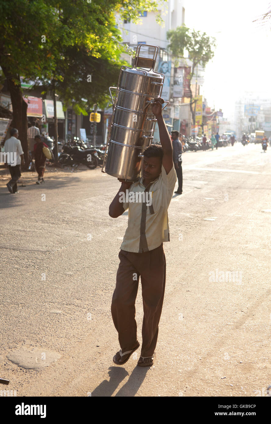 Indian man carrying steel food containers Stock Photo - Alamy