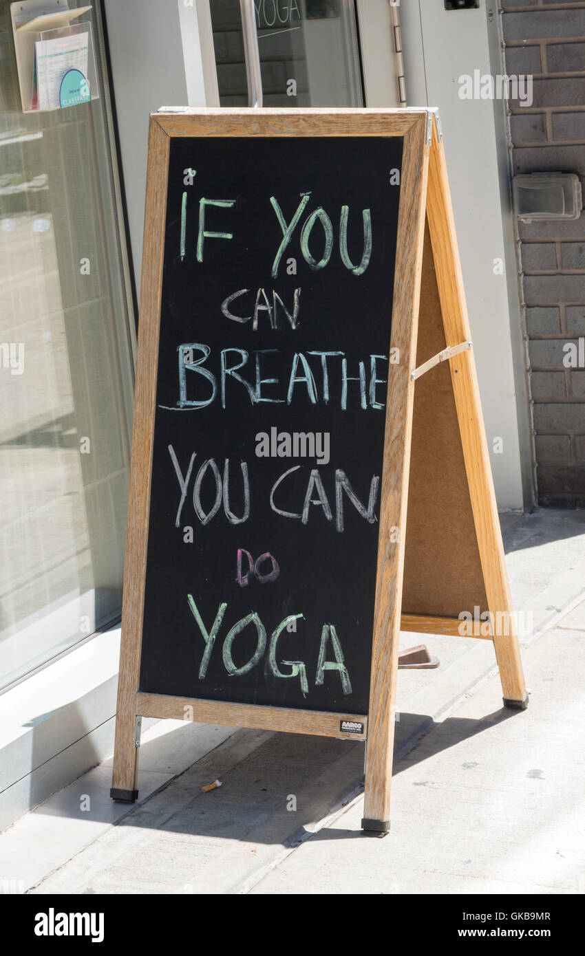 A blackboard sign with inspiring and encouraging phrase about yoga ...