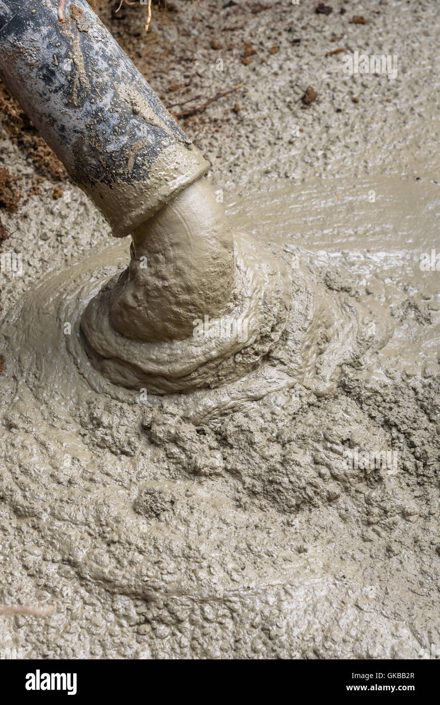 Concrete pumping hose filling foundation hole Stock Photo - Alamy