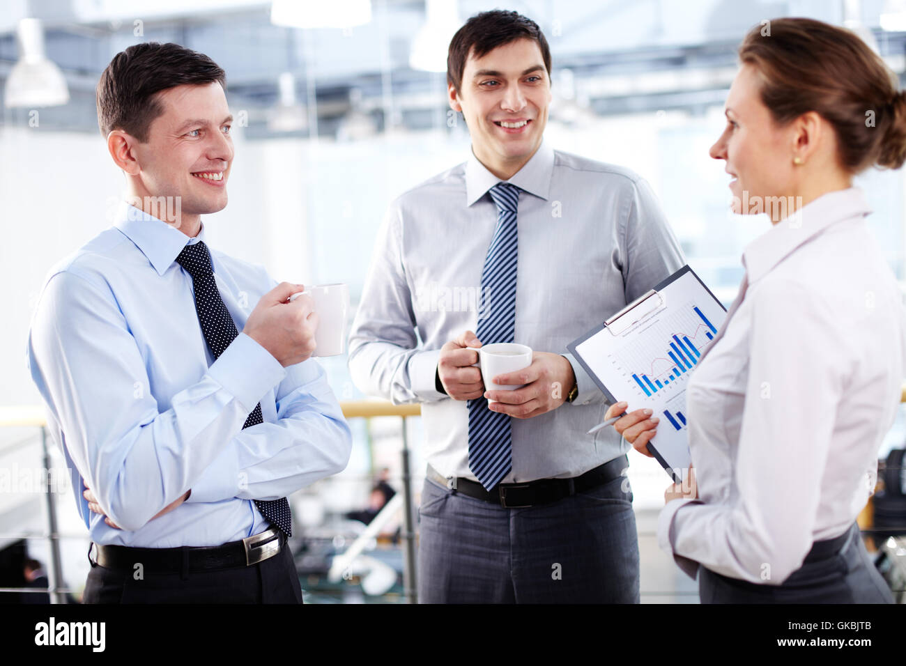 Positive delighted colleagues talking hi-res stock photography and ...