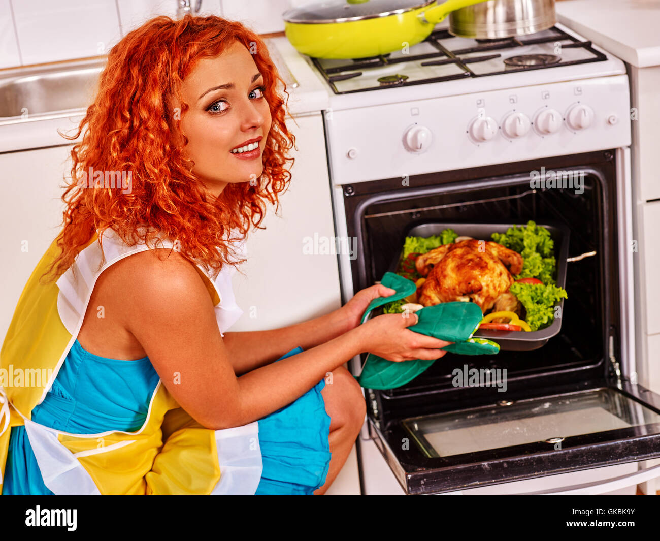 Woman cooking chicken at kitchen Stock Photo - Alamy