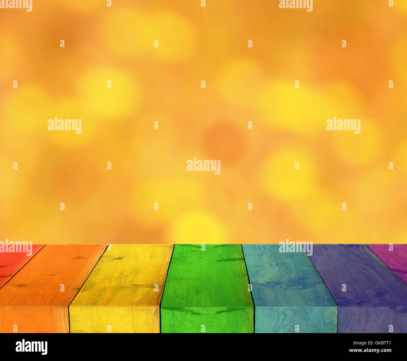 table from multicolored wooden boards with blurred light background ...