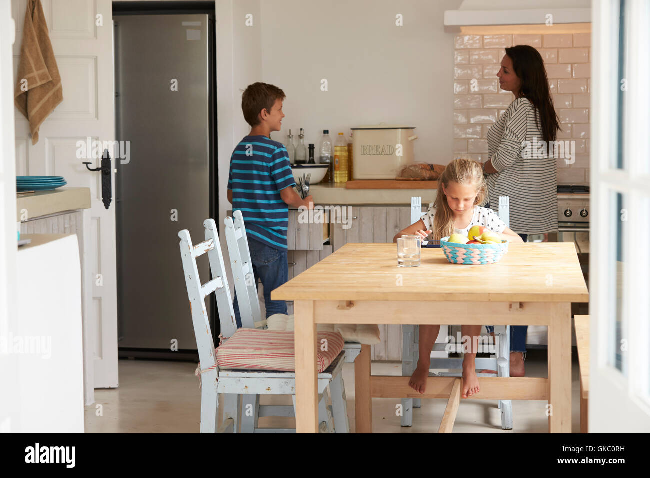 Children Helping To Lay Table For Family Meal Stock Photo - Alamy