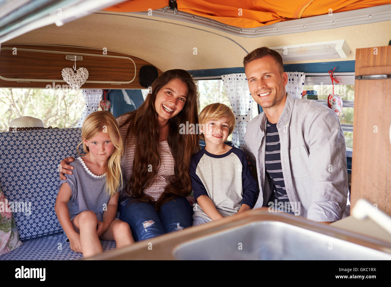 Smiling family portrait inside camper van Stock Photo - Alamy