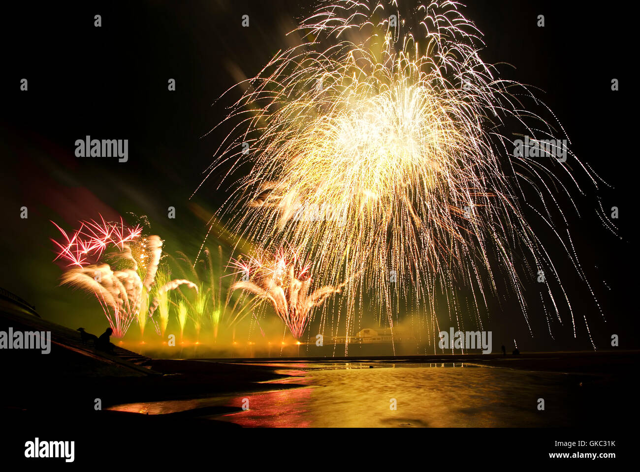 Fireworks over a pier at the seaside Stock Photo - Alamy