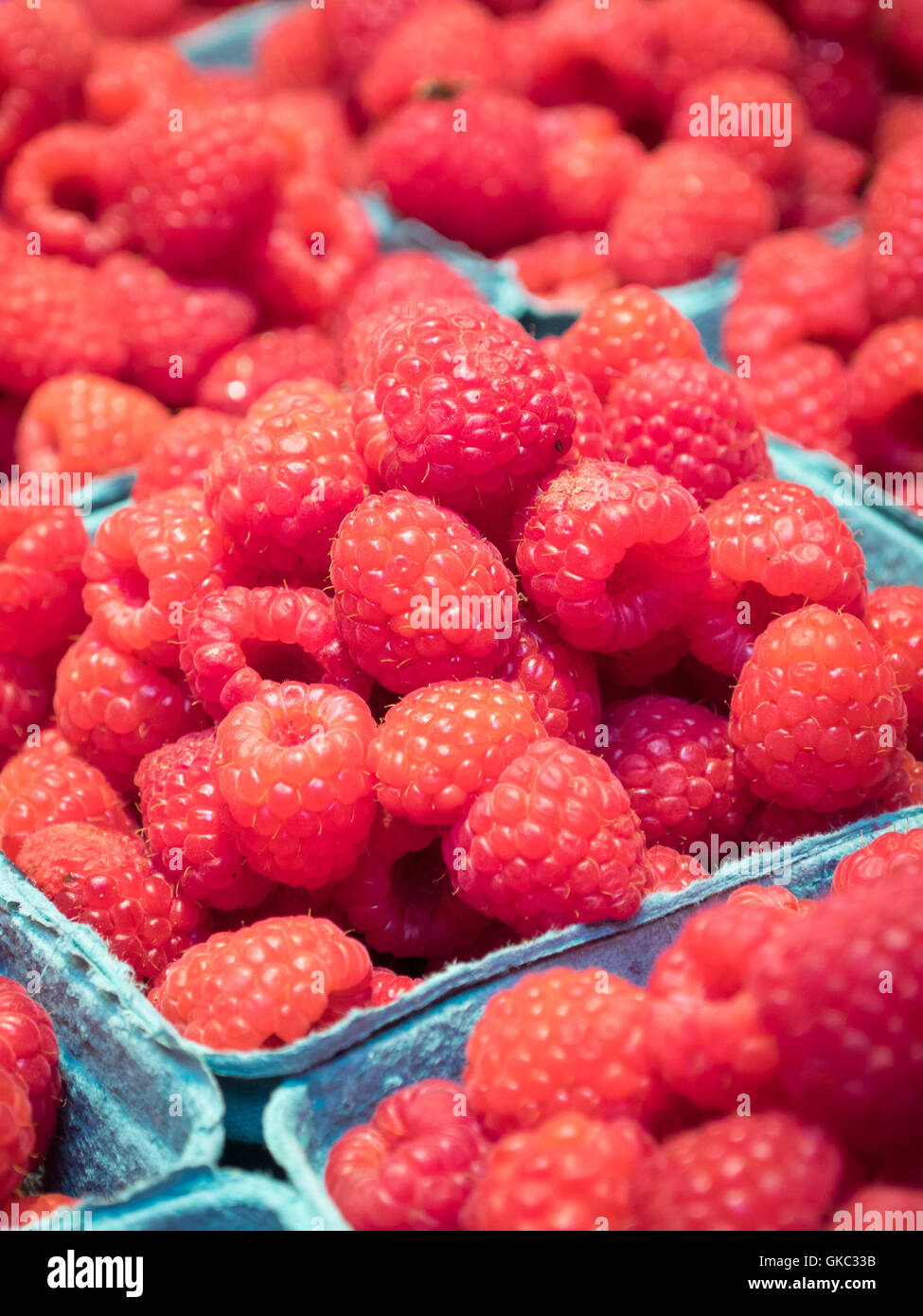 Punnets of fresh raspberries for sale at Granville Island Public Market ...
