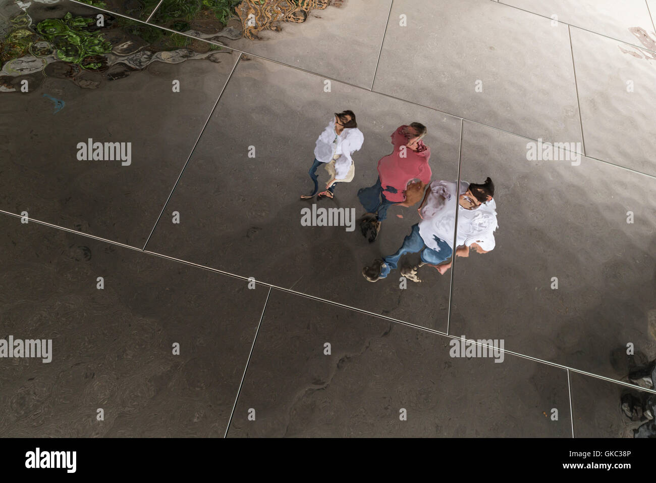 contorted reflections of people in a ceiling with mirrors Stock Photo ...