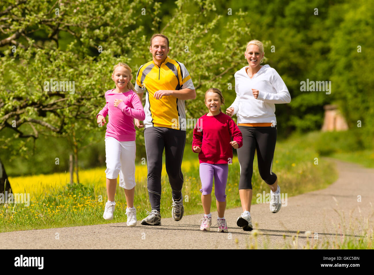 family jogging as a sport in nature Stock Photo - Alamy