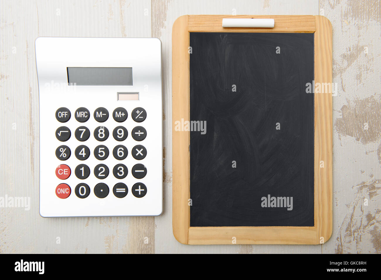 chalkboard and calculator on woolen table Stock Photo - Alamy
