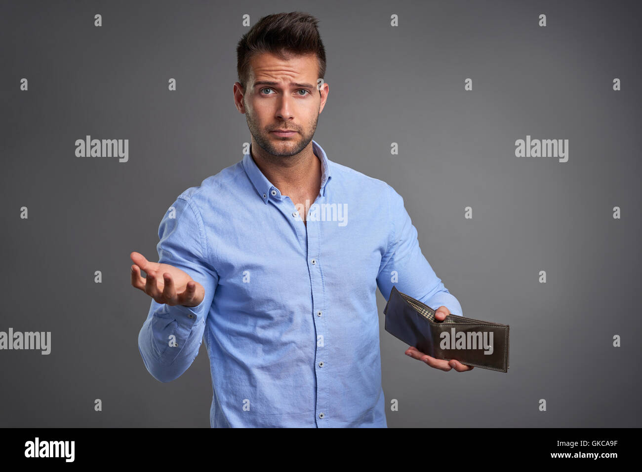 A poor handsome young man feeling stressed looking in to the camera and ...