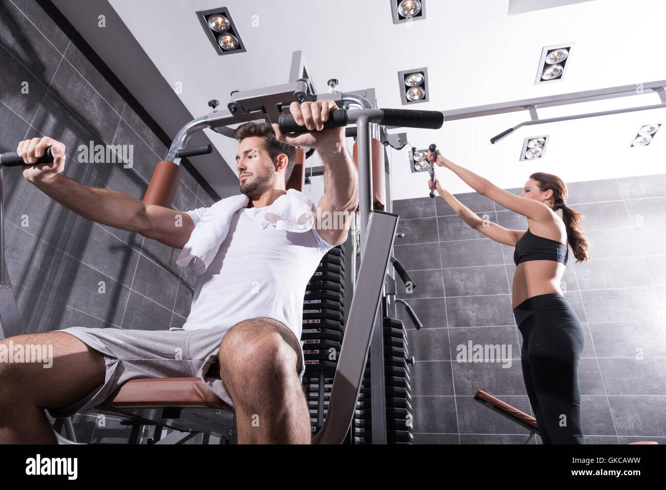 A young couple training together in the Gym Stock Photo - Alamy