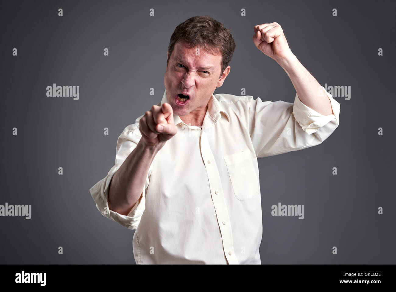 Portrait of a angry middle age man getting fury Stock Photo - Alamy