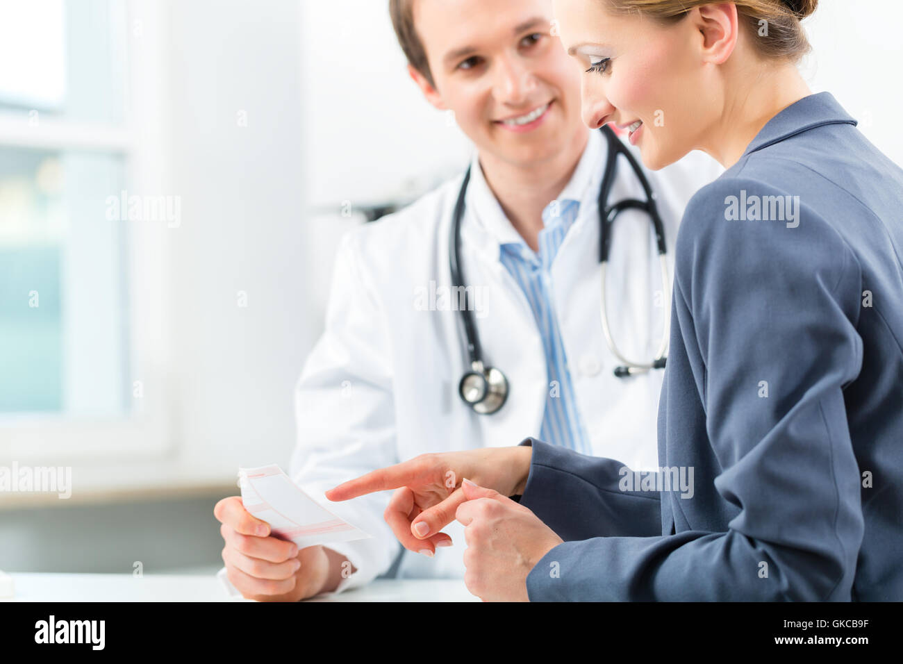 doctor with patient during counseling Stock Photo - Alamy