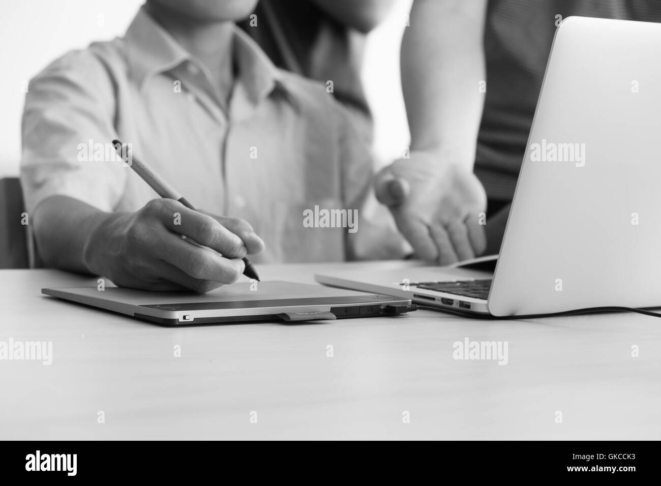 Graphic Designer working with interactive pen on meeting room,black and ...