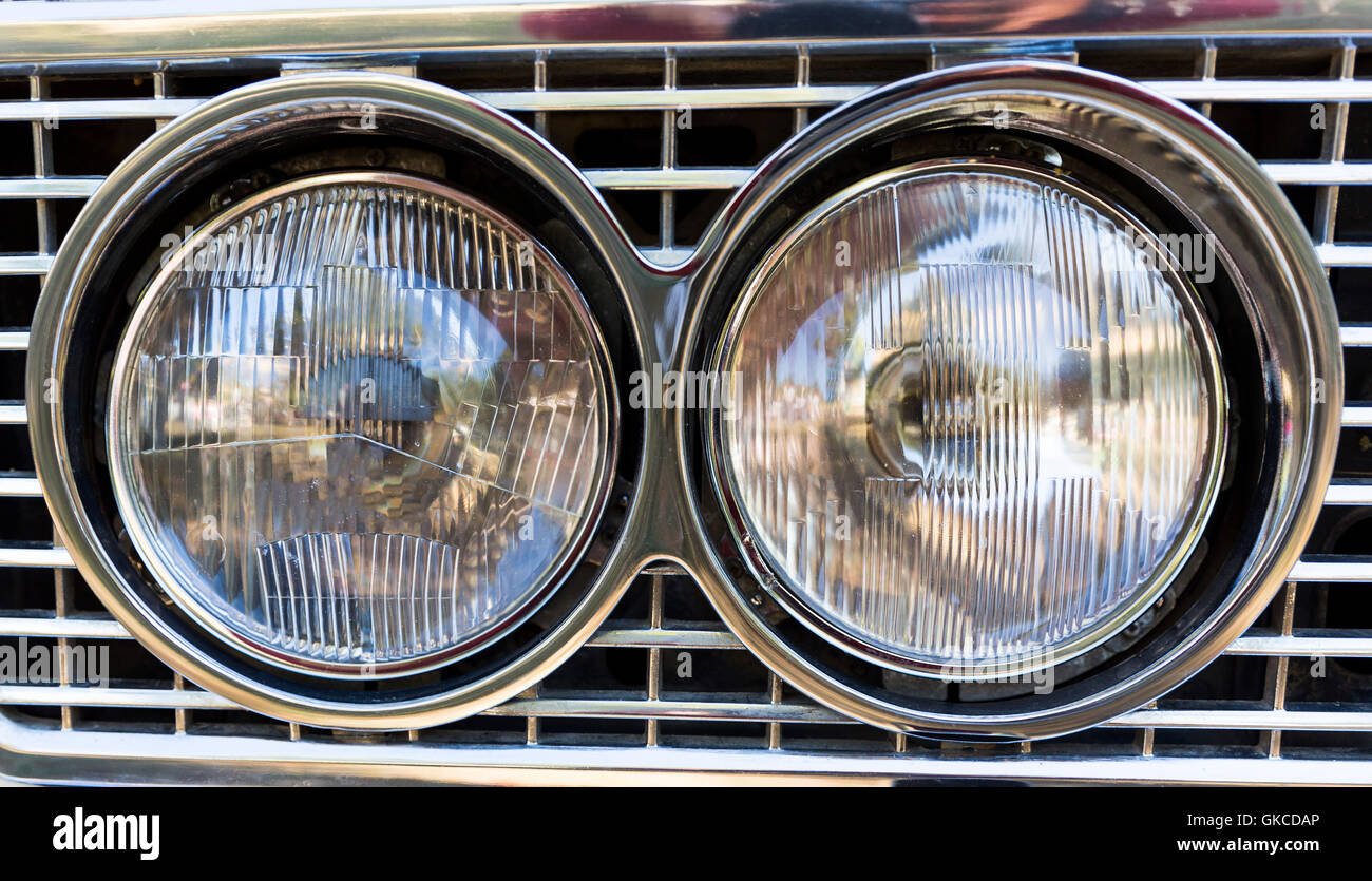 Detail of an attique car at a retro car parade. Two headlights ...