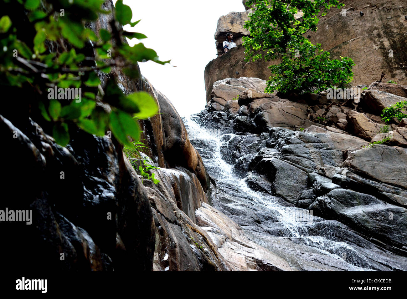 Water flowing in the Garvaji waterfall with greenery and rocks Stock ...
