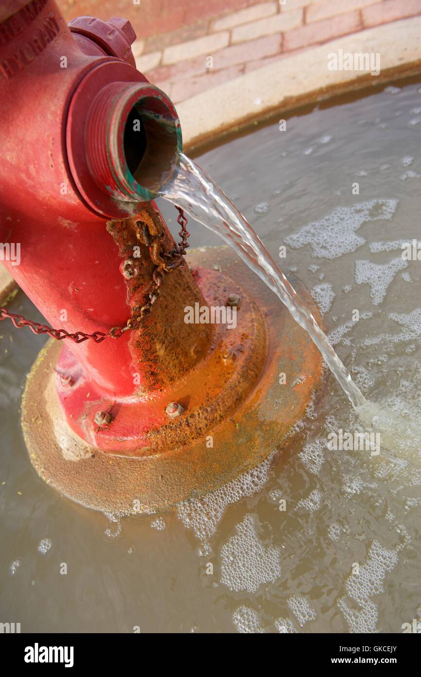 Red Fire Hydrant with Running Water pouring out Stock Photo - Alamy
