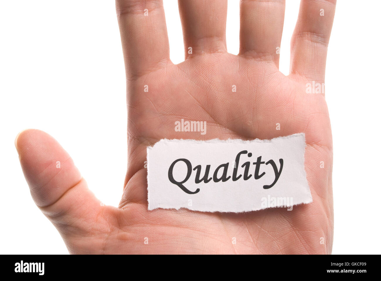 Quality word in hand Stock Photo - Alamy