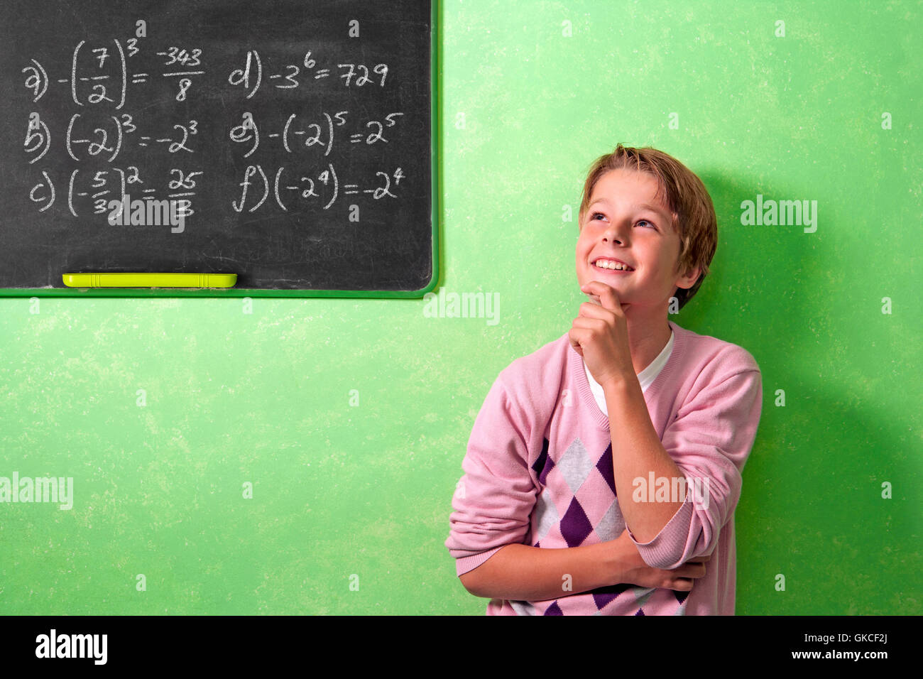 Boy in classroom with wondering expression Stock Photo - Alamy