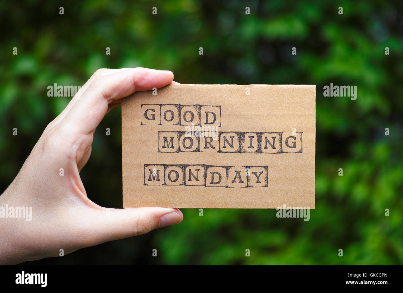 Woman hand holding cardboard card with words Good Morning Monday made ...