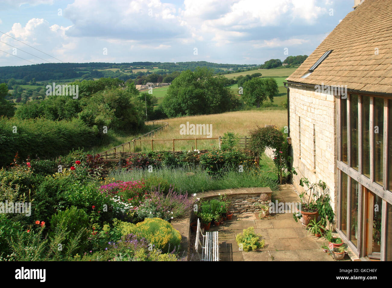 UK. A garden patio terrace seating area with open countryside views ...