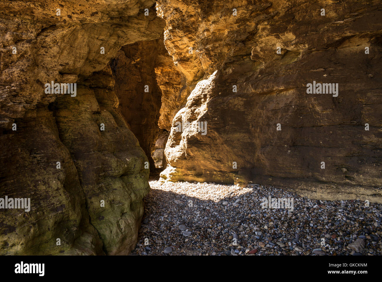 Caves eroded from cliffs of yellow coloured Magnesian Limestone rock at ...
